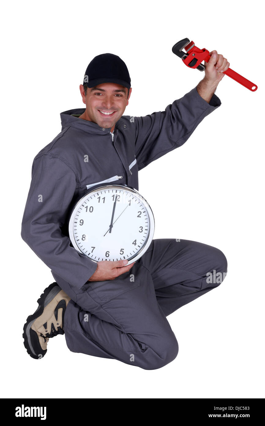 Mechanic with a clock showing noon Stock Photo - Alamy
