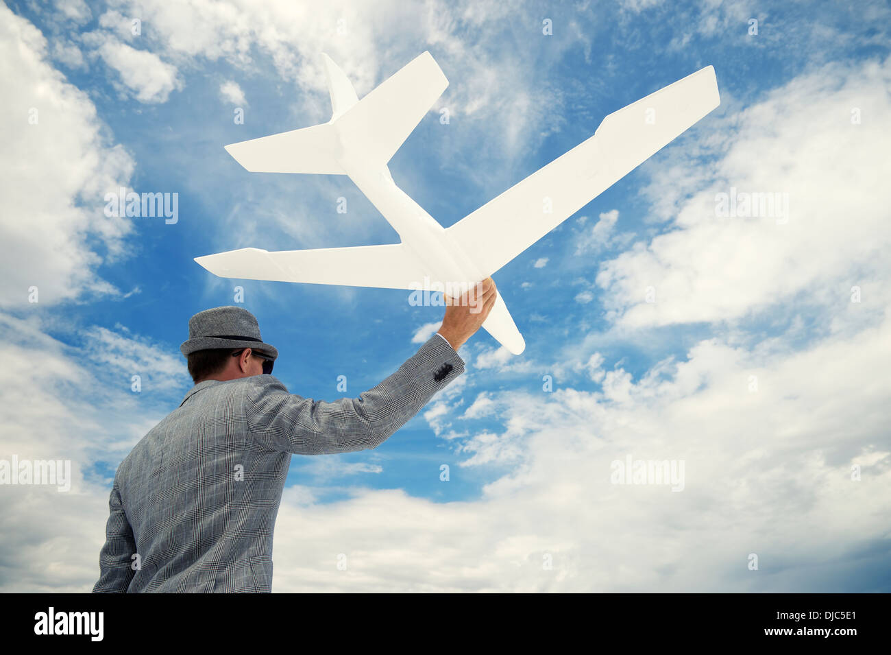 Entrepreneur businessman sends white model airplane flying against blue ...