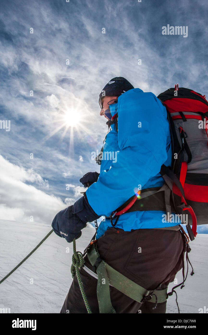 A client following the guide on the glacier Stock Photo - Alamy