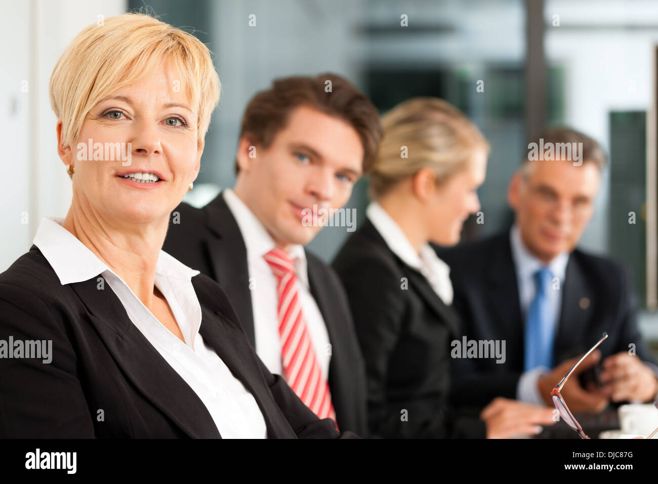 Business - team in an office, the female boss is looking into the ...