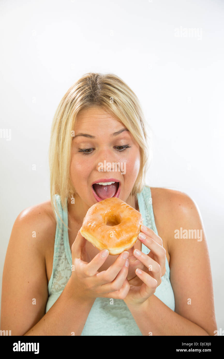 Woman eating doughnut hi-res stock photography and images - Alamy