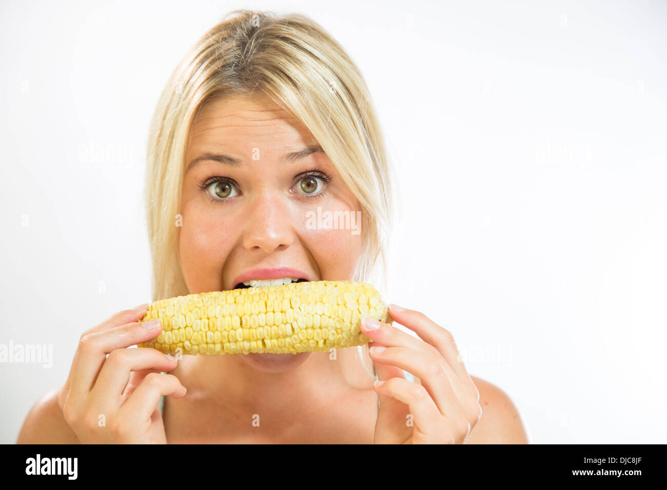 Young woman eating corn Stock Photo - Alamy