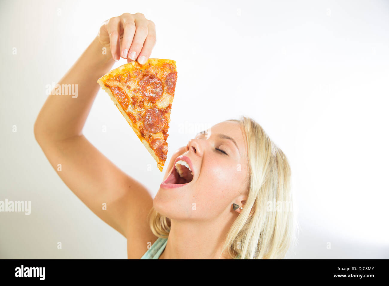 Woman eating pizza hi-res stock photography and images - Alamy