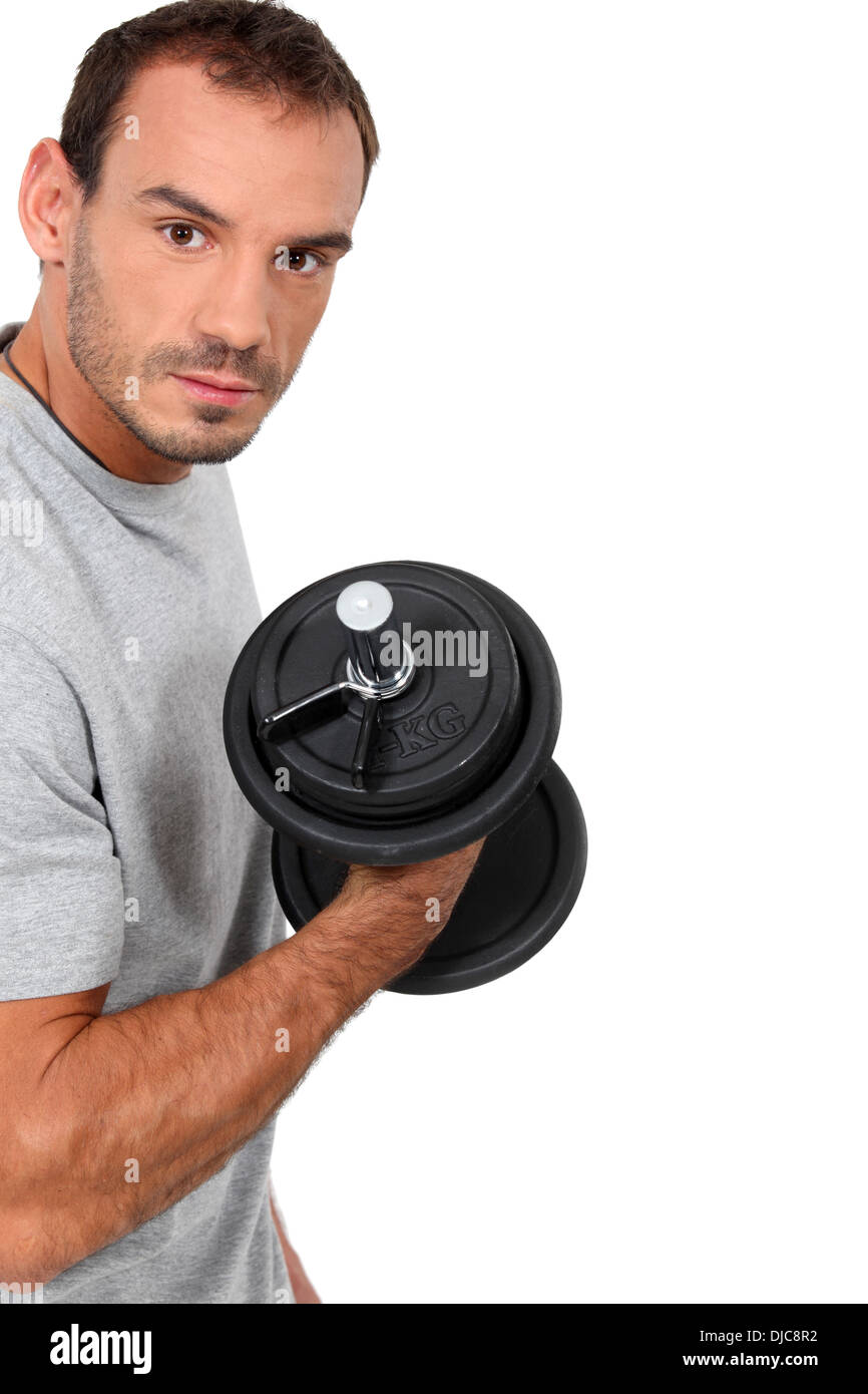 Muscular man lifts dumbbell hi-res stock photography and images - Alamy
