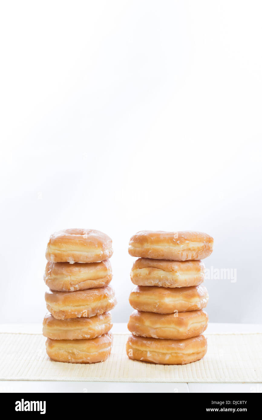 Two stacks of glazed donuts Stock Photo - Alamy