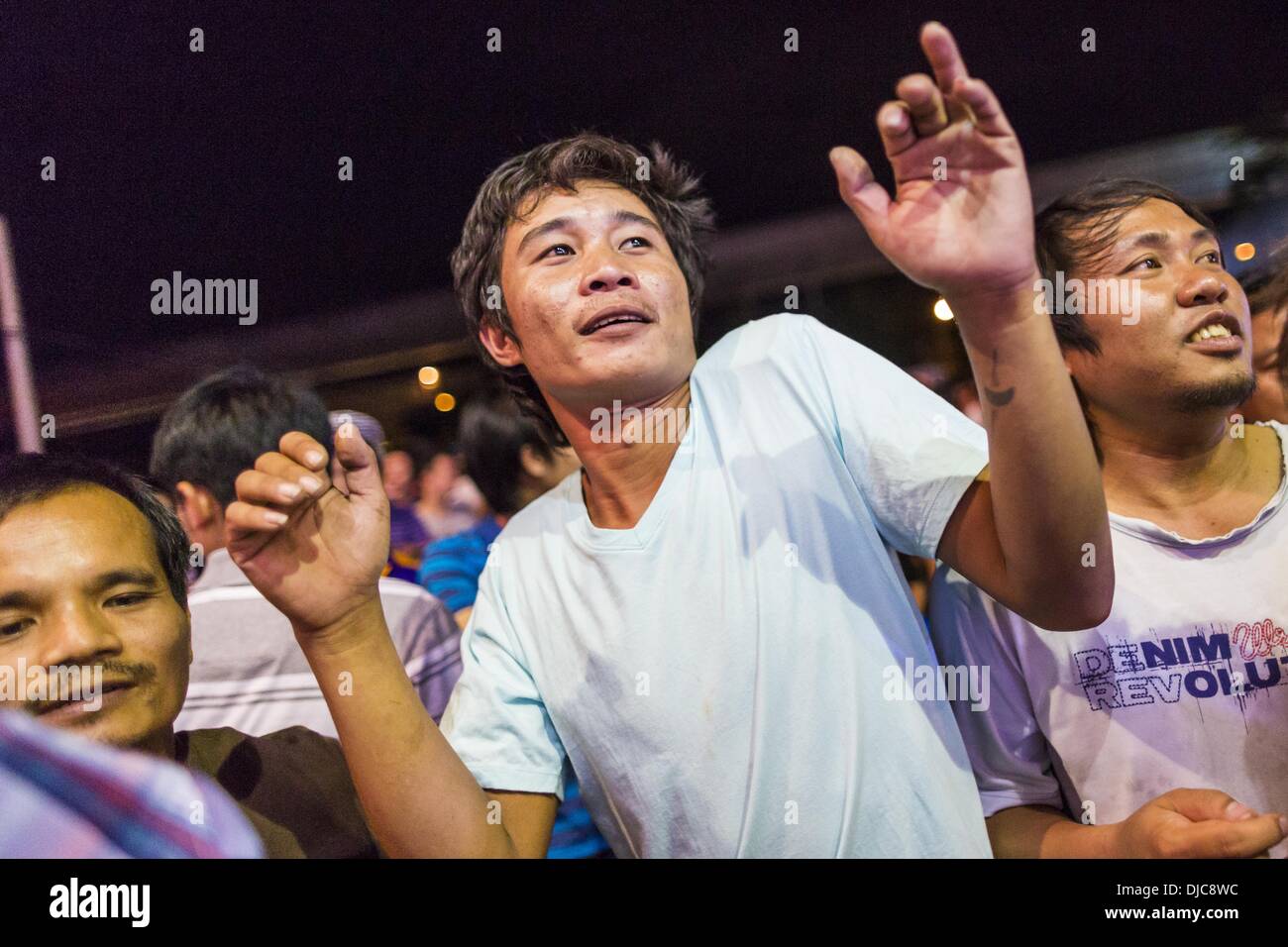 Bangkok, Thailand. 23rd Nov, 2013. Spectators dance during a Prathom ...