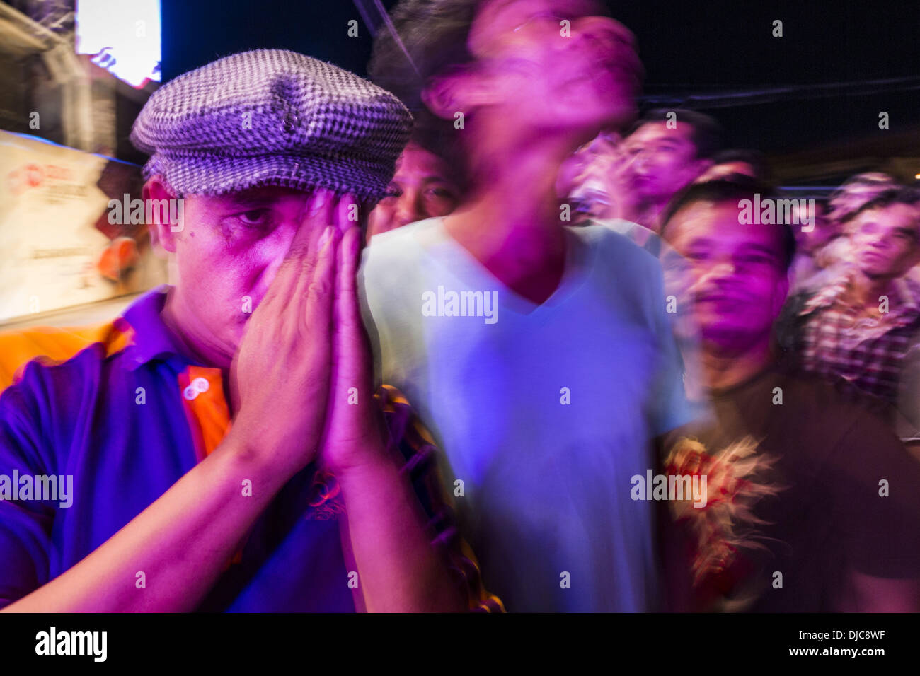 Bangkok, Thailand. 23rd Nov, 2013. A spectator at a Mor Lam show bows ...