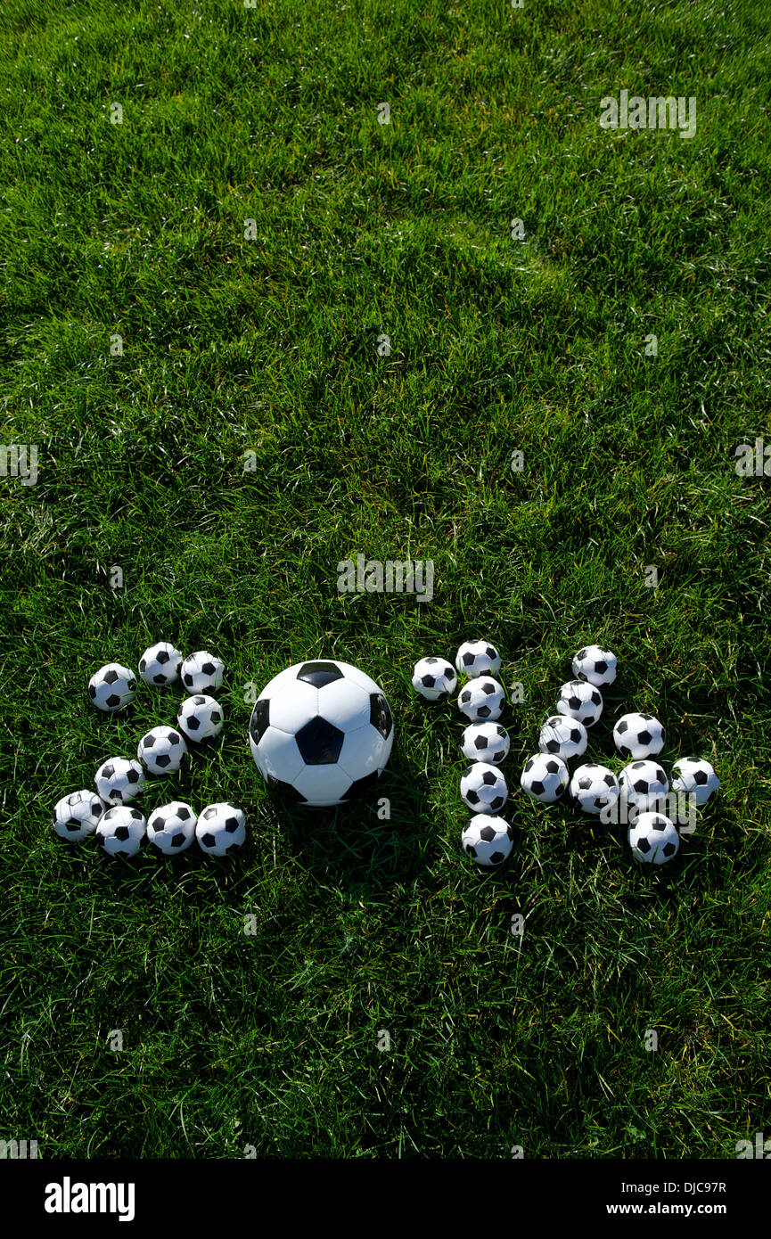 Message for 2014 made with small soccer balls on green grass football ...