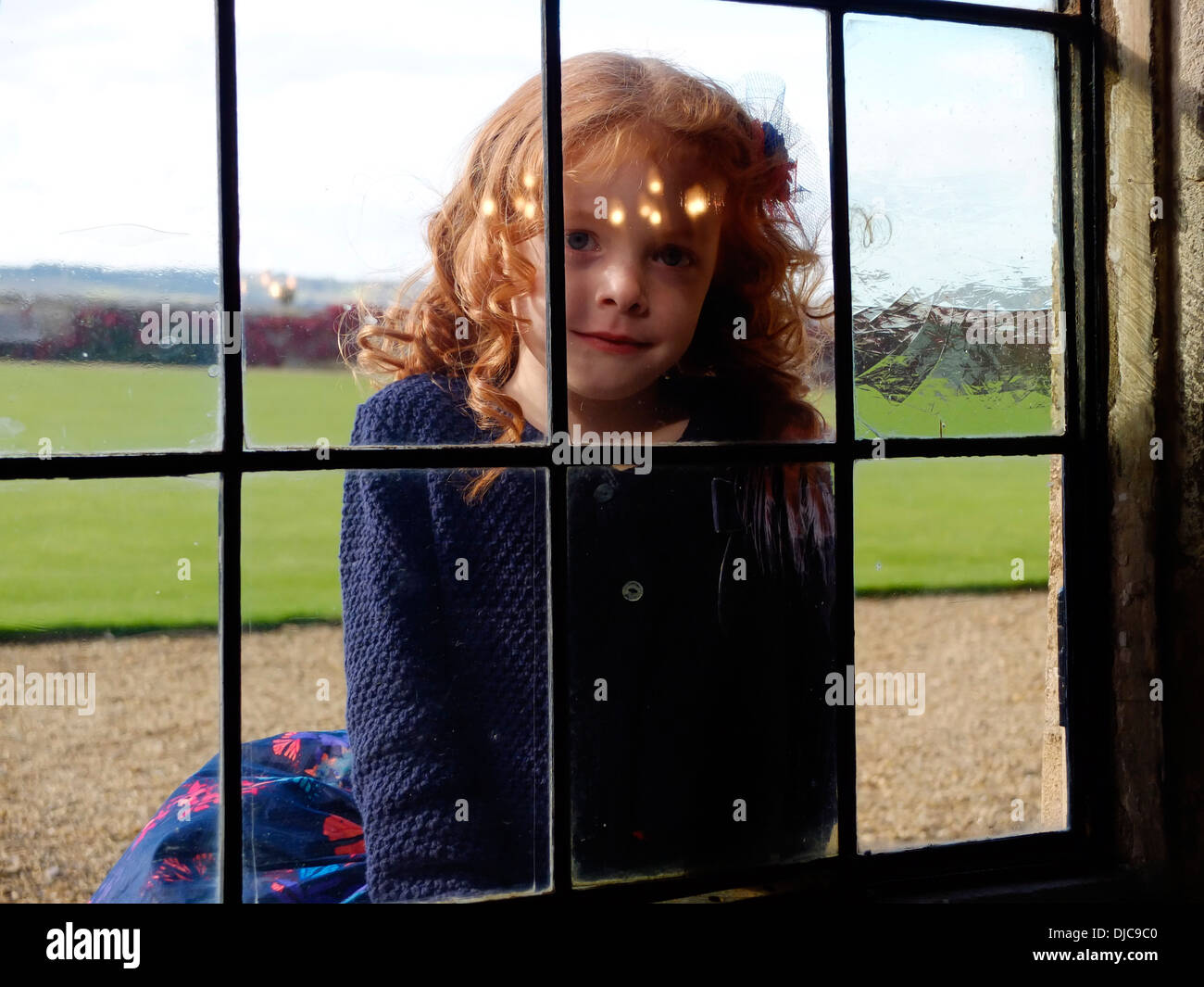 Child looking through a window Stock Photo - Alamy