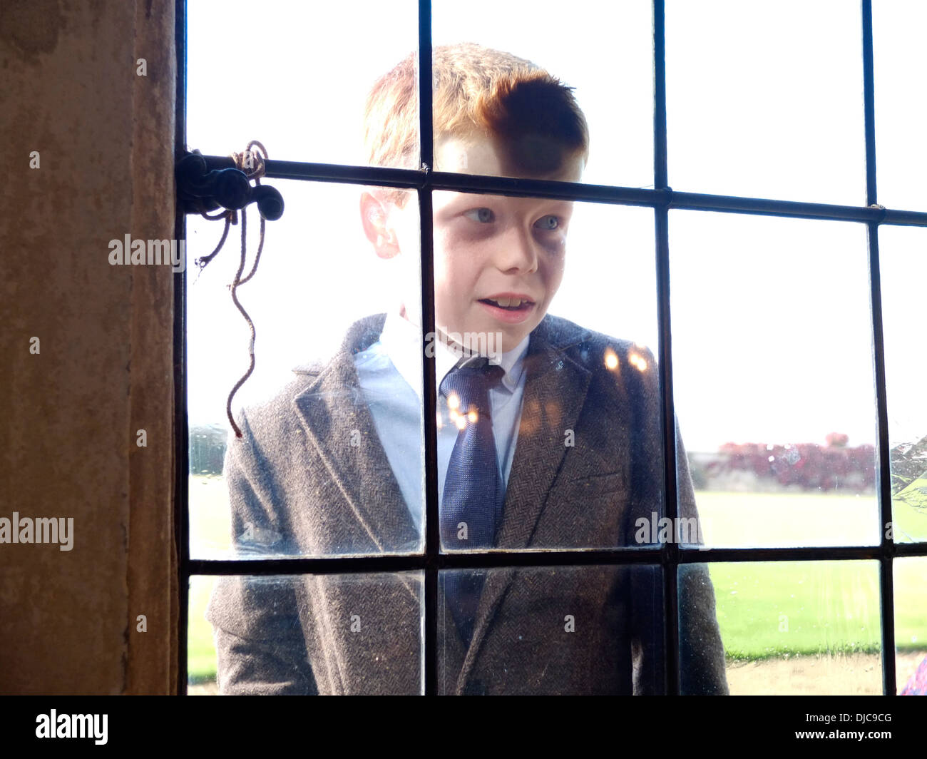 Child looking through a window Stock Photo - Alamy