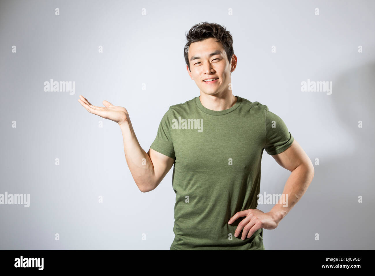 Athletic young male holding palm face up Stock Photo - Alamy