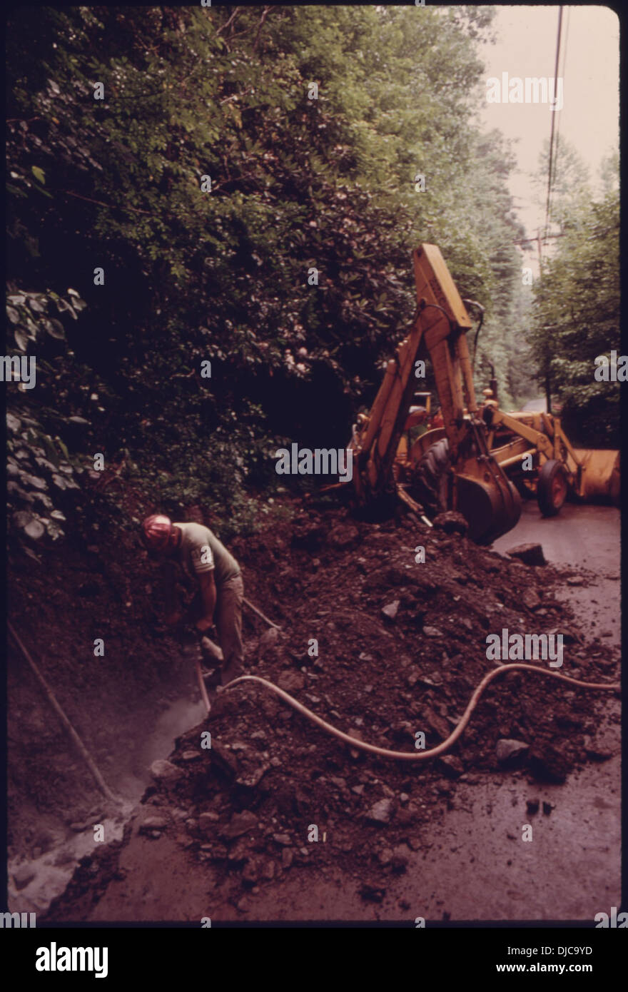 A construction worker is drilling through solid rock along Escowee ...