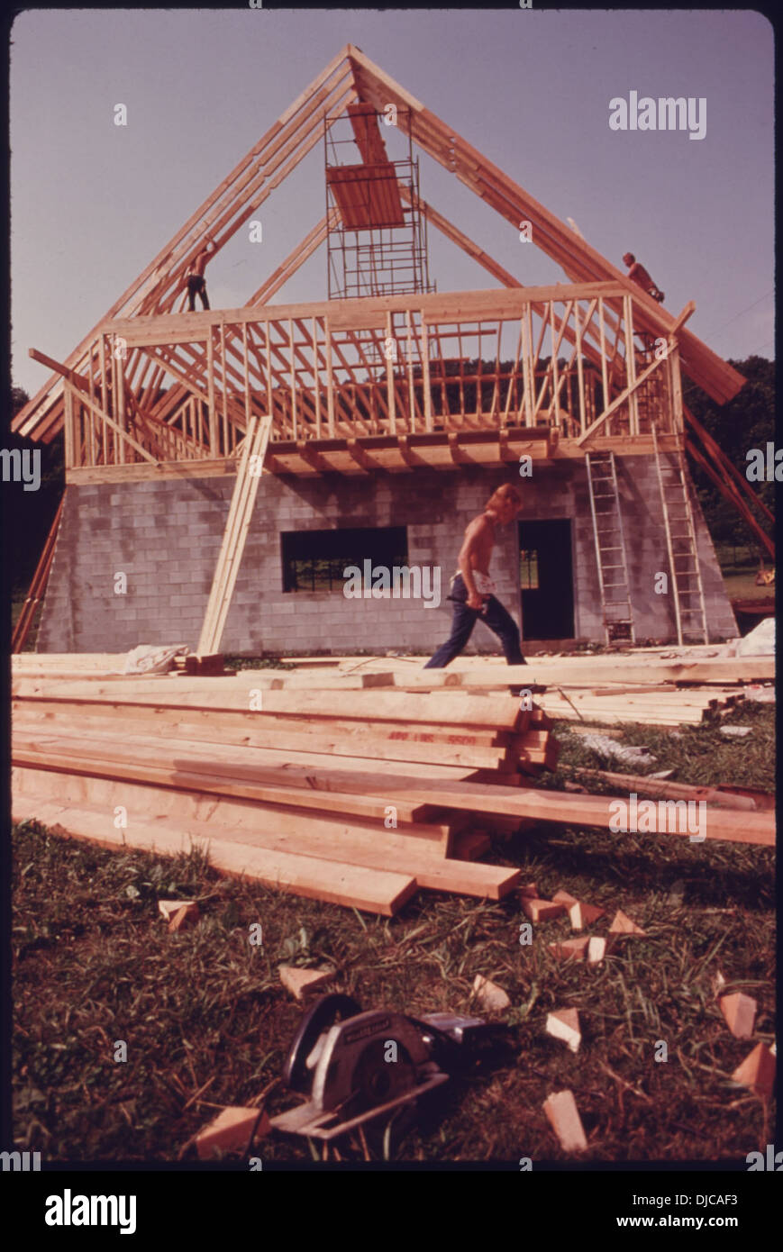 Carpenters are seen constructing the first unit of the Alpine Village ...