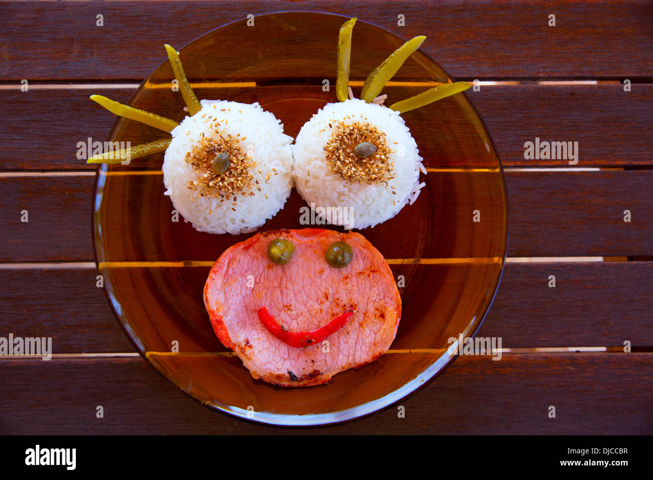 Funny kid food with rice and meat with a smiley face Stock Photo - Alamy