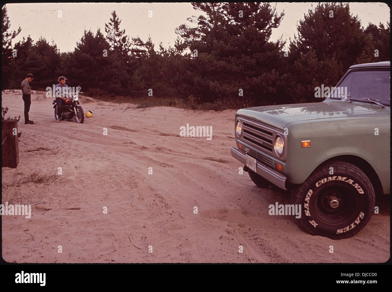 A motorcyclist receives a ticket for riding a motorcycle on the sand ...