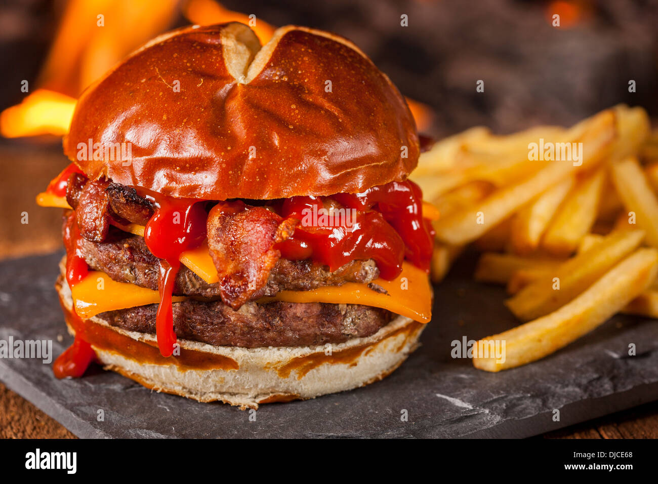 Unhealthy Homemade Barbecue Bacon Cheeseburger with Fries Stock Photo ...