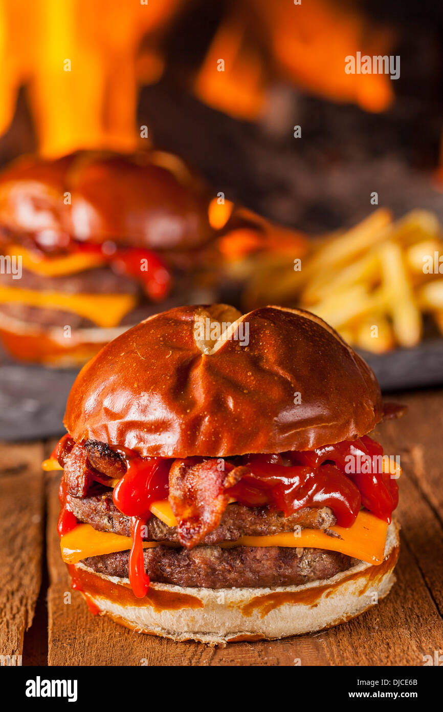 Unhealthy Homemade Barbecue Bacon Cheeseburger with Fries Stock Photo ...
