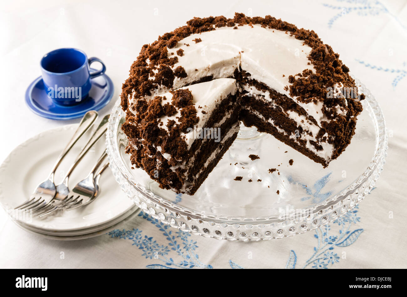 Chocolate crumb layer cake with white icing Stock Photo - Alamy
