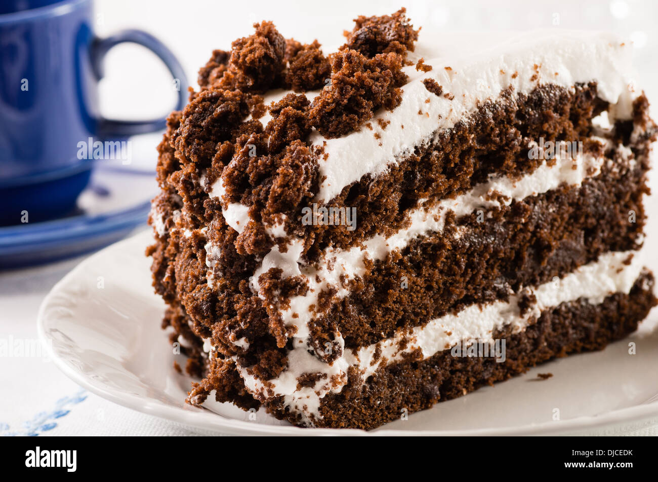 Chocolate crumb layer cake with white icing Stock Photo - Alamy