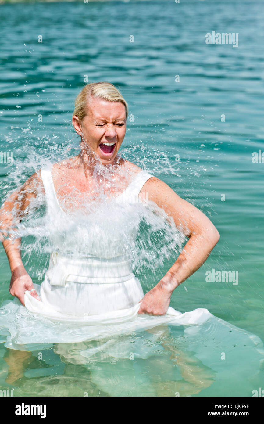 Germany, Bavaria, Tegernsee, Wet bride in lake, laughing Stock Photo ...