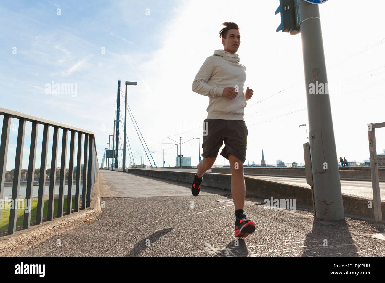 Germany, North Rhine Westphalia, Duesseldorf, Mid adult man jogging ...