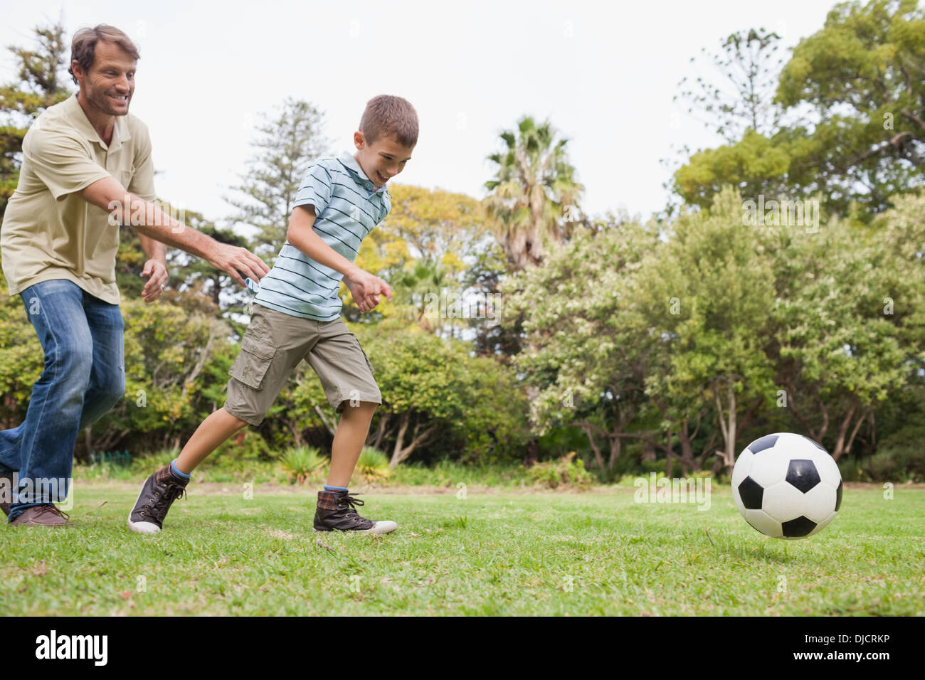 Son playing football with his father Stock Photo - Alamy