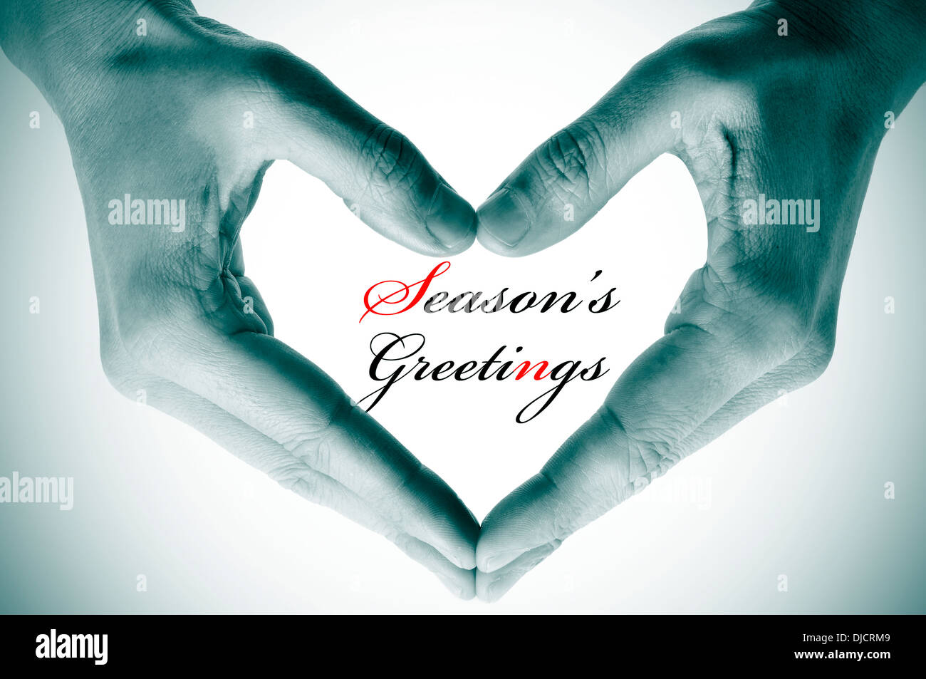 man hands forming a heart and the sentence seasons greetings Stock ...