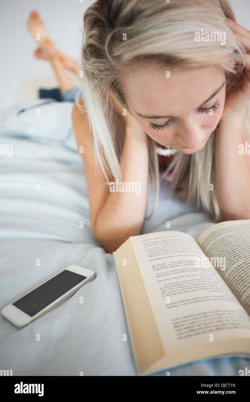 Gorgeous calm blonde reading a book Stock Photo - Alamy
