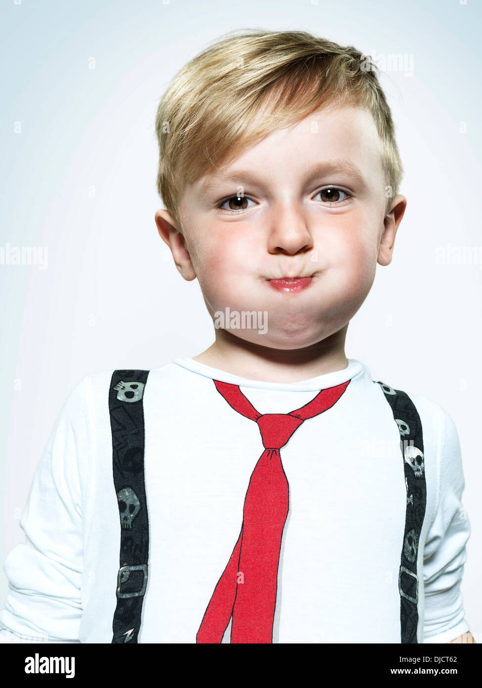 Portrait of little boy blowing his cheeks, studio shot Stock Photo - Alamy