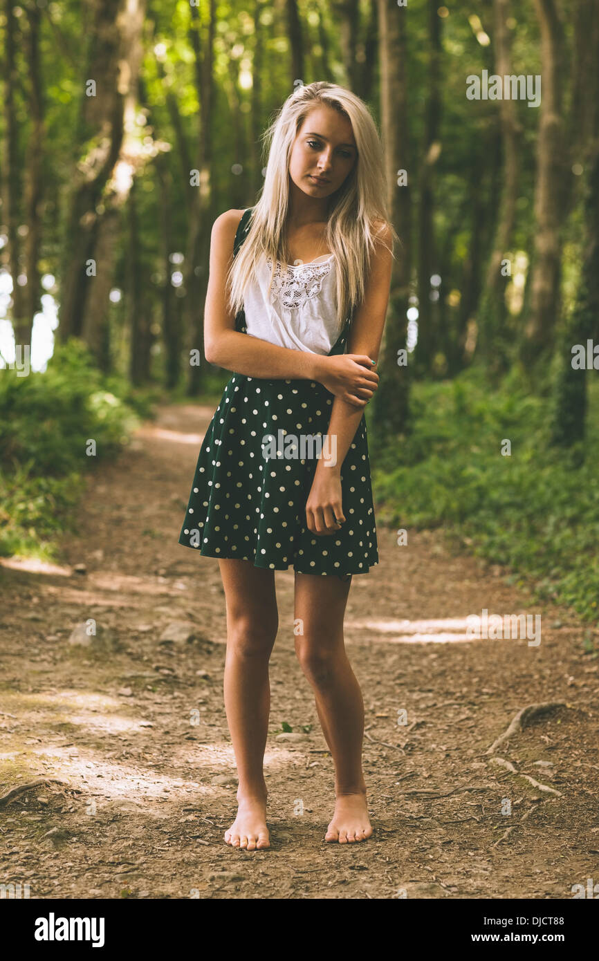 Serious gorgeous blonde standing on forest track Stock Photo - Alamy