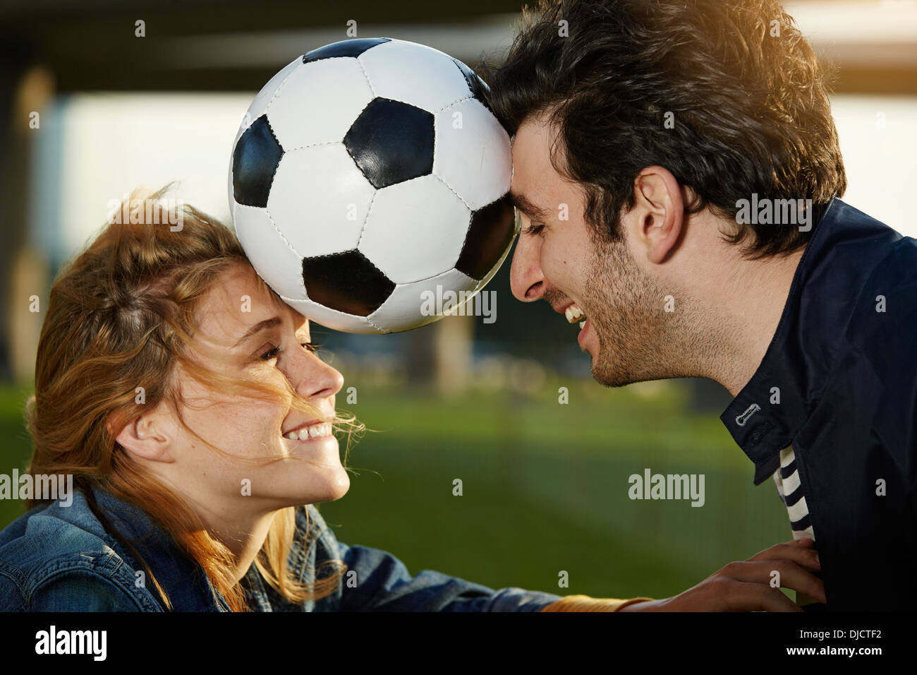 Germany, Dusseldorf, Young couple playing football Stock Photo - Alamy