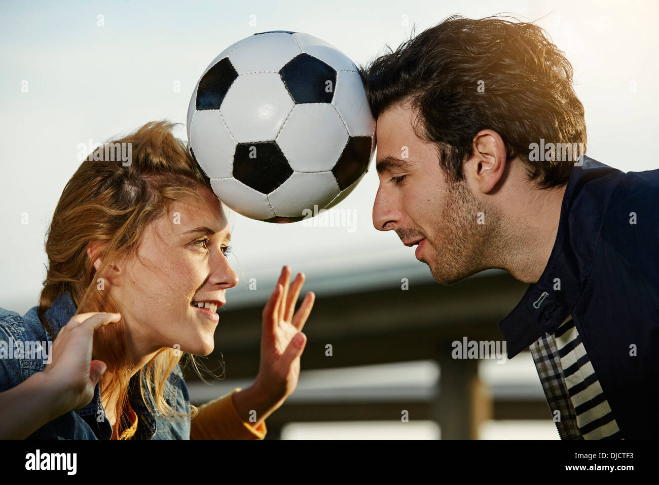 Germany, Dusseldorf, Young couple playing football Stock Photo - Alamy
