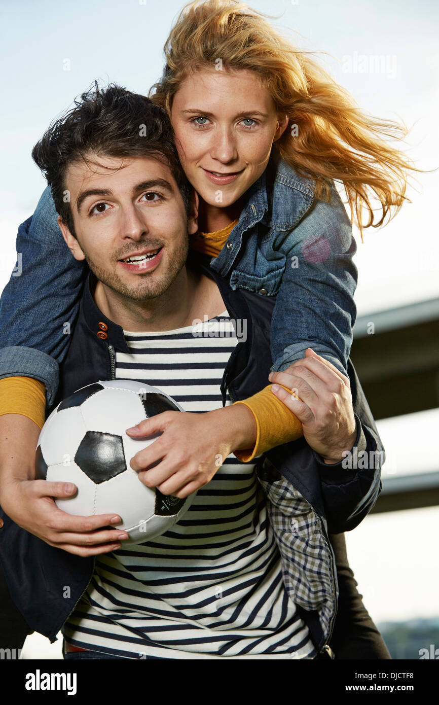 Germany, Dusseldorf, Young couple playing football Stock Photo - Alamy