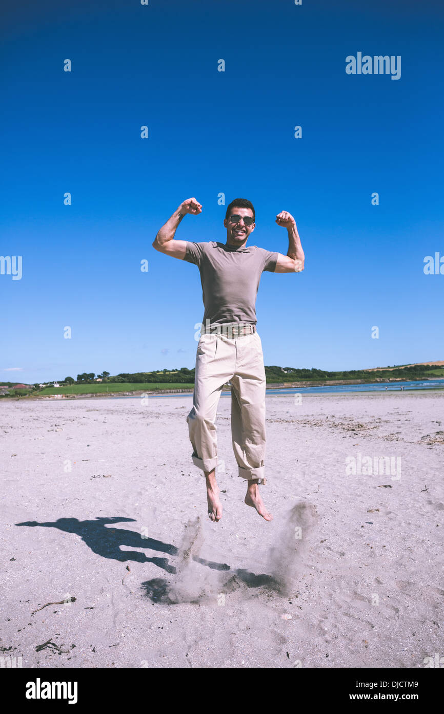 Attractive happy man jumping in the air Stock Photo - Alamy