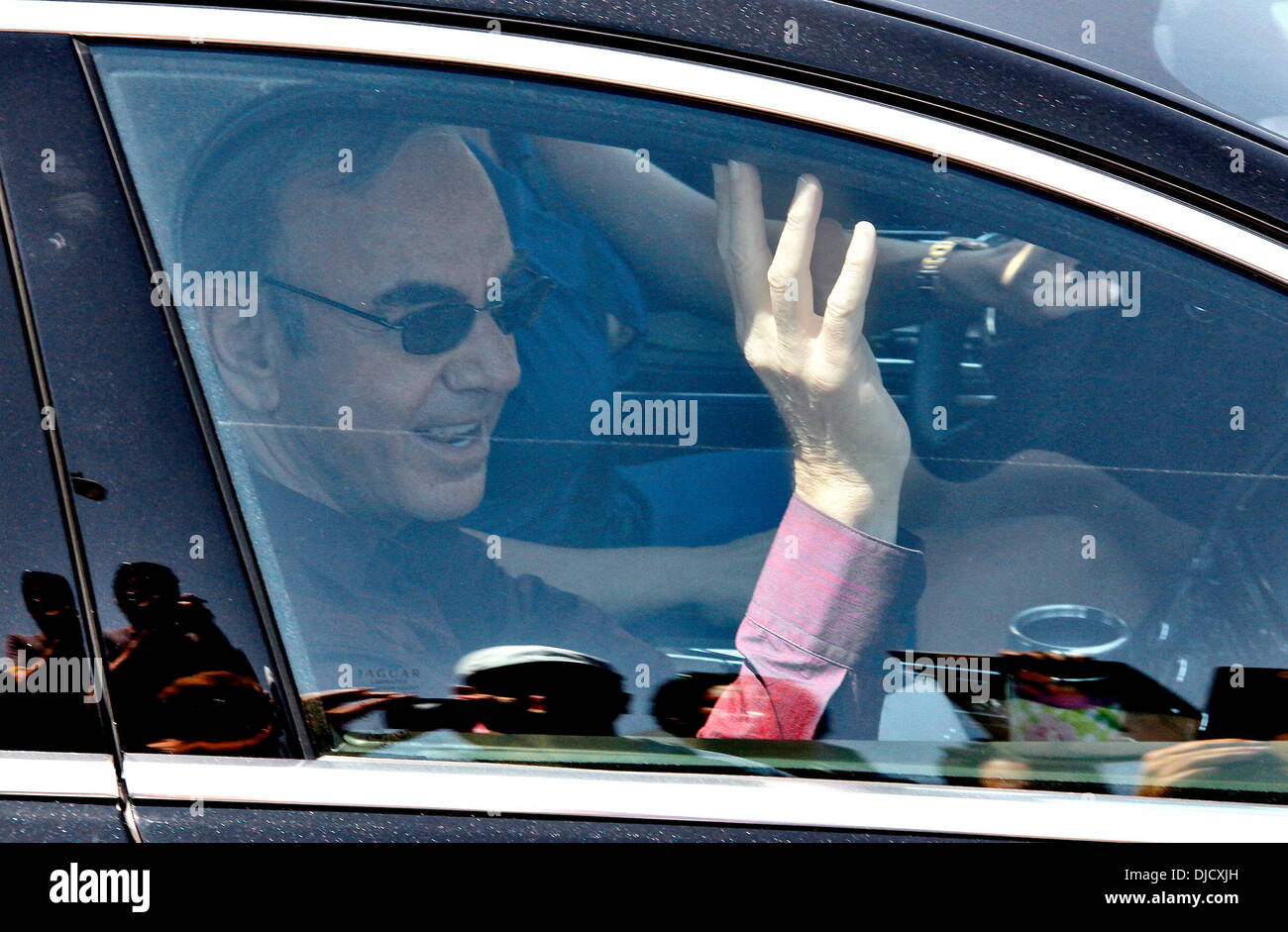 Neil Diamond waves from his car, after being honoured with a star on ...