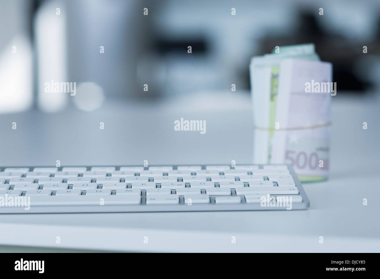 Keyboard and money on desk Stock Photo - Alamy