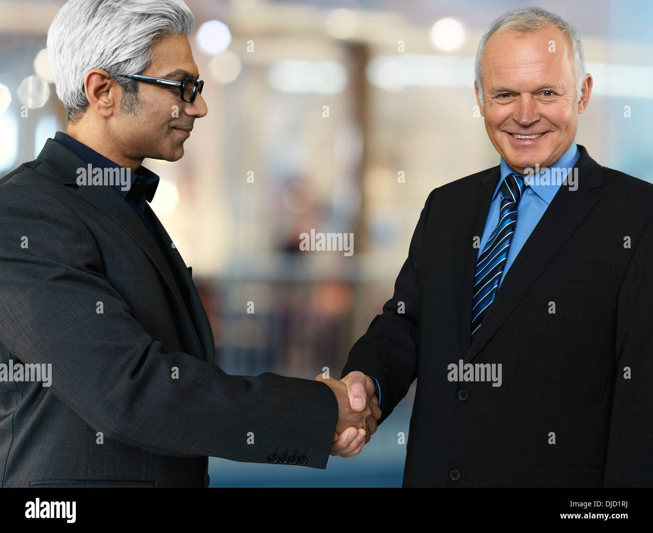 Portrait of two business partners shaking hands Stock Photo - Alamy