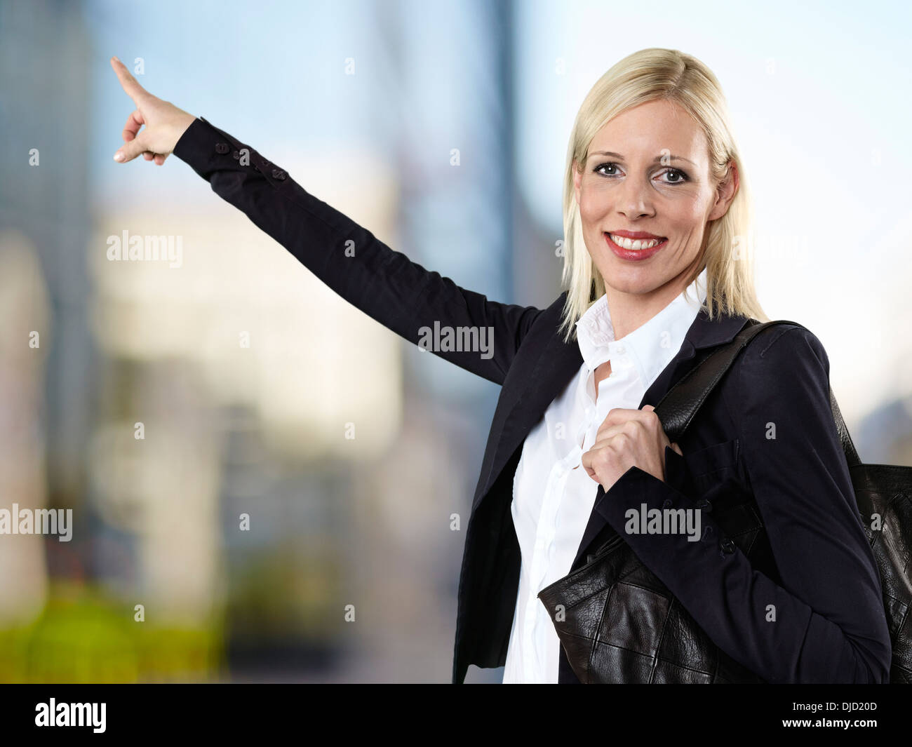 Portrait of business woman pointing at something Stock Photo - Alamy