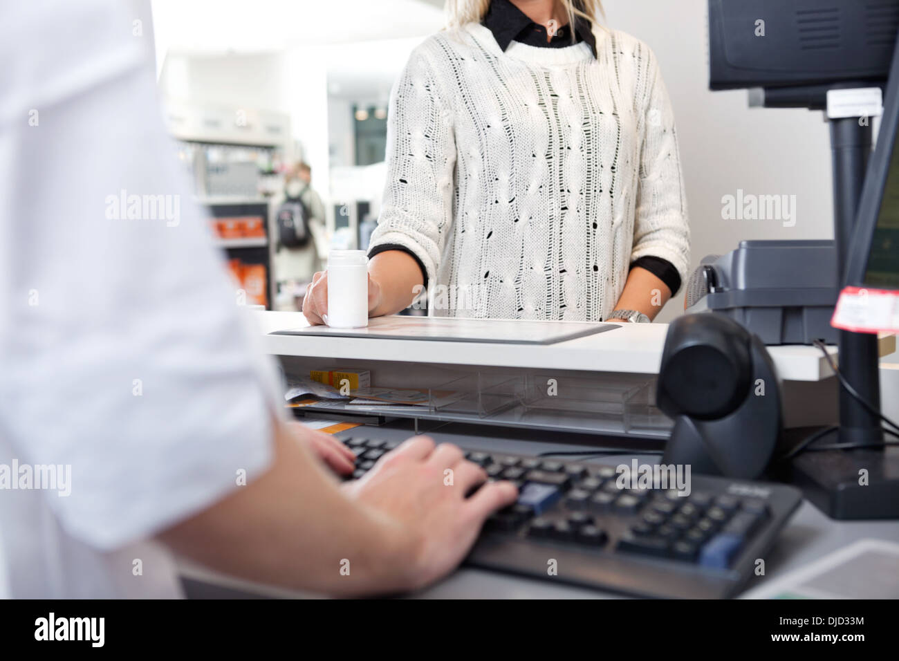 Customer Standing at Checkout Counter Stock Photo - Alamy