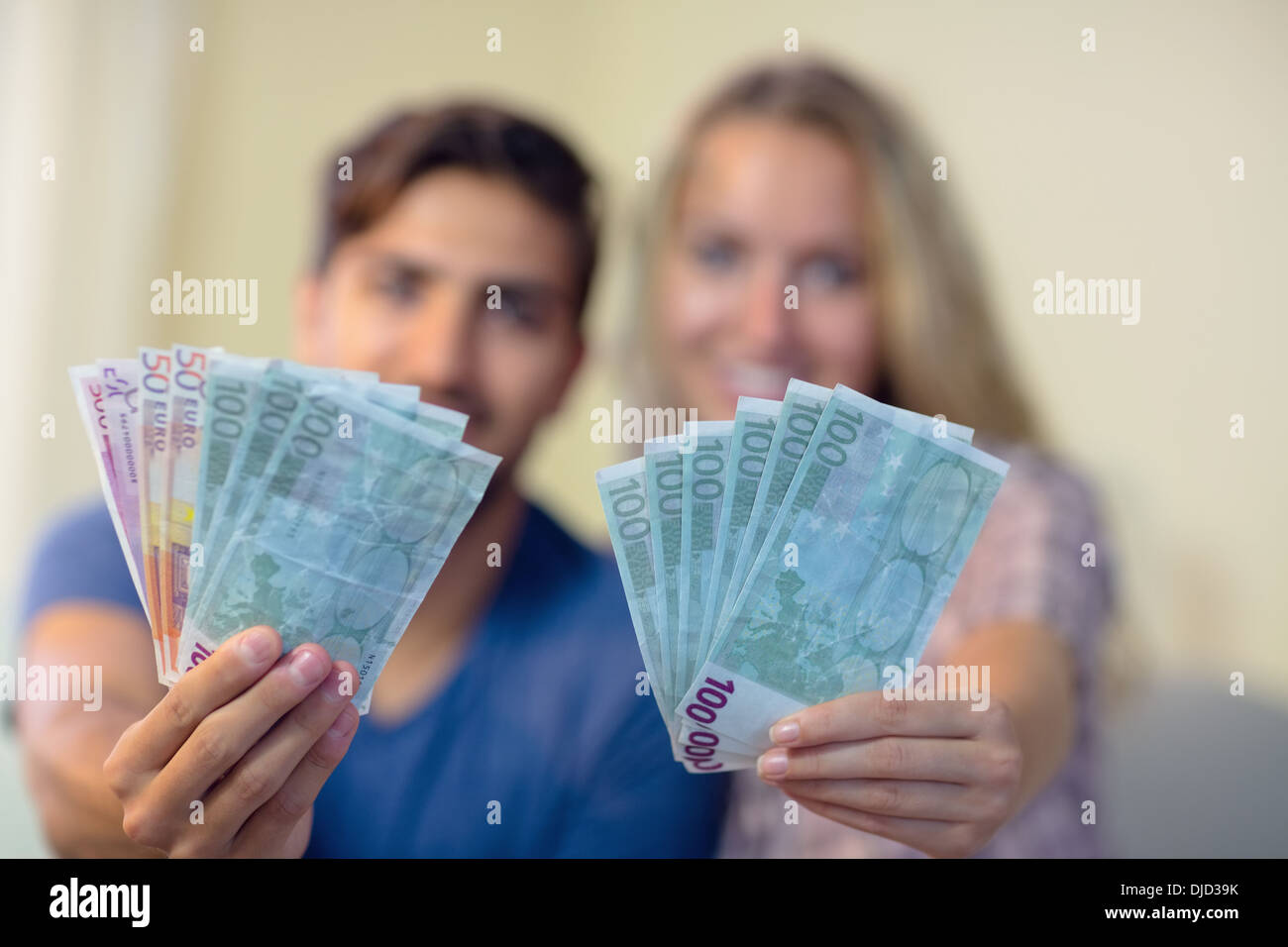 Cheerful couple showing money Stock Photo - Alamy
