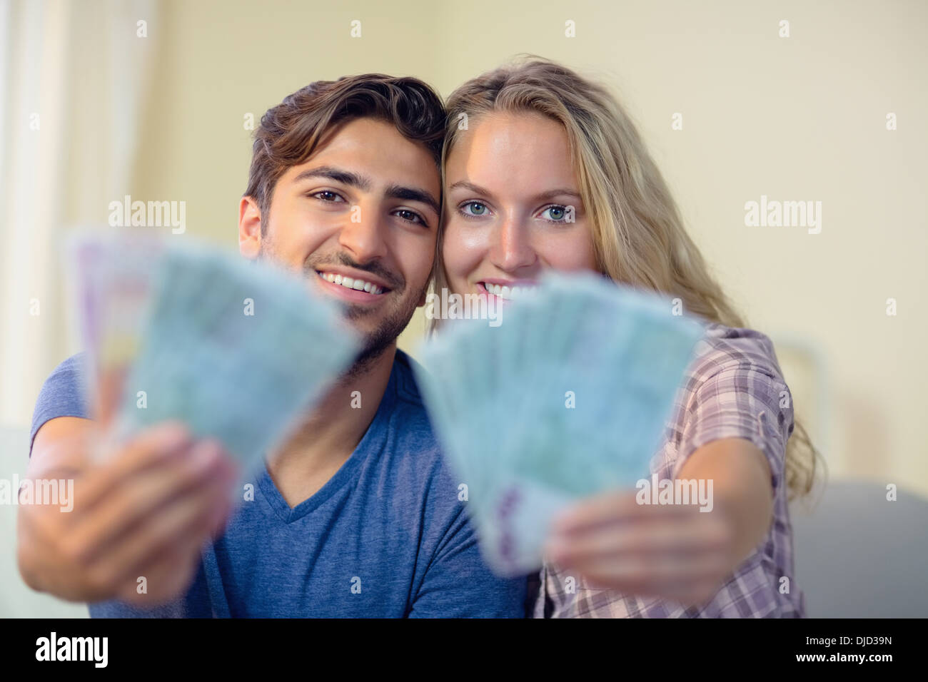 Happy couple showing some money Stock Photo - Alamy
