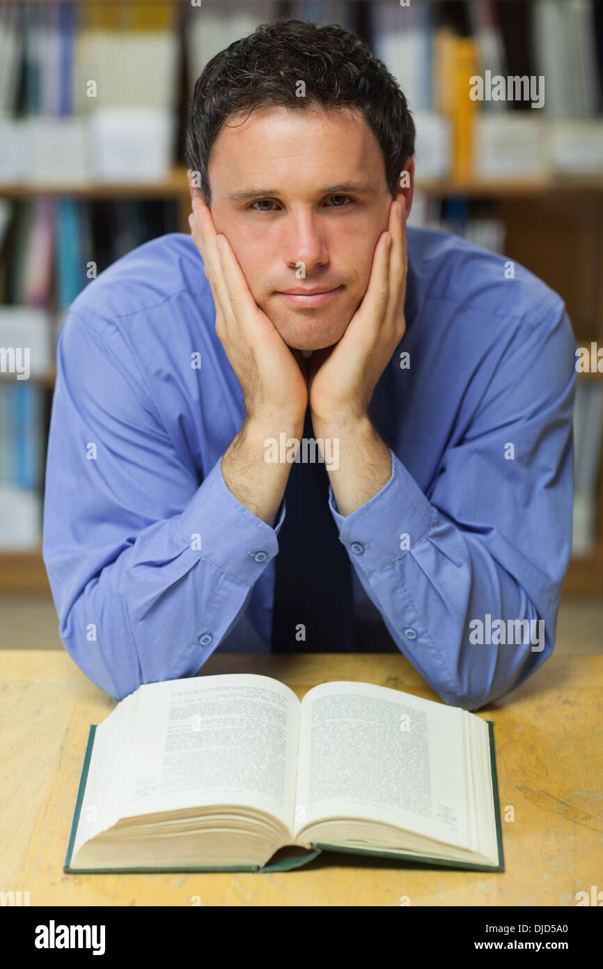Serious librarian reading a book Stock Photo - Alamy