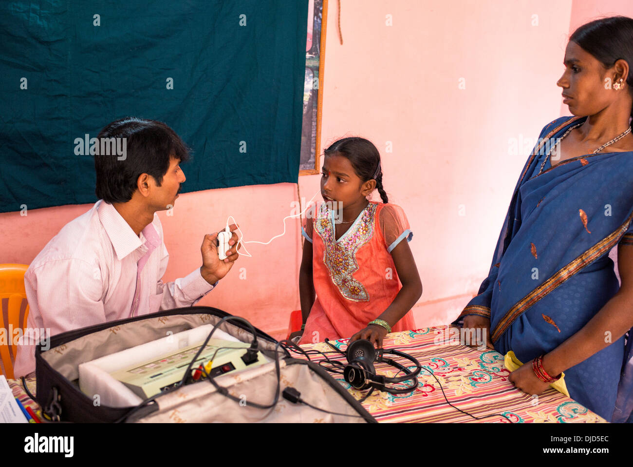 Deaf Indian village girl trying out a hearing aid at Sathya Sai Baba ...