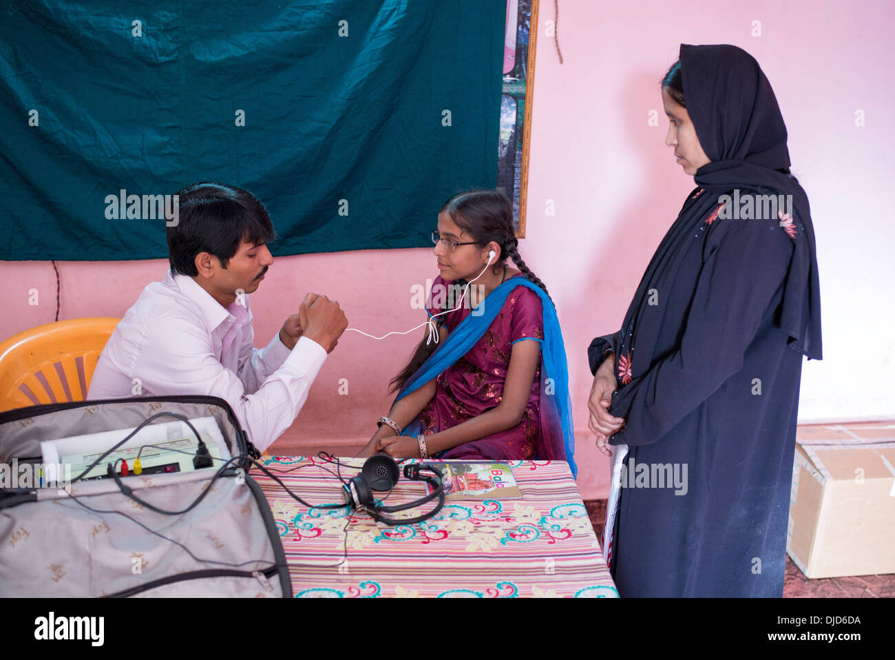 Deaf Indian village girl trying out a hearing aid at Sathya Sai Baba ...