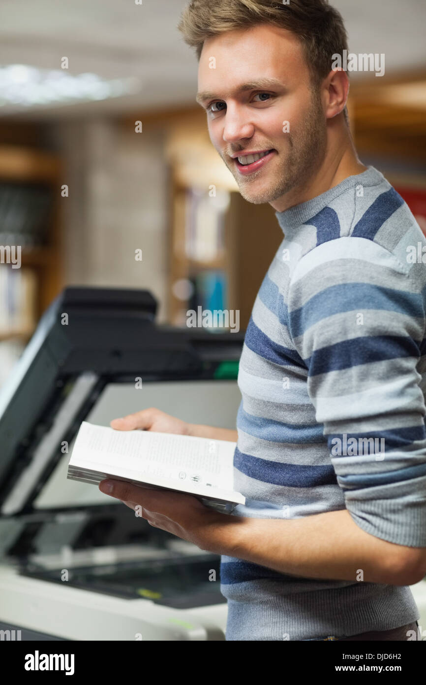 Man standing in front bookshelf hi-res stock photography and images - Alamy