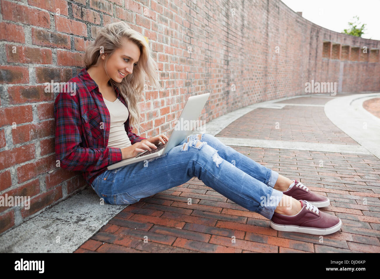 Woman sitting leaning against wall hi-res stock photography and images ...