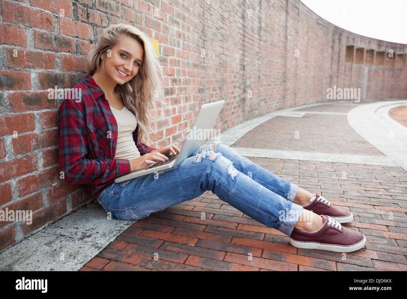 Leaning against wall sitting hi-res stock photography and images - Alamy