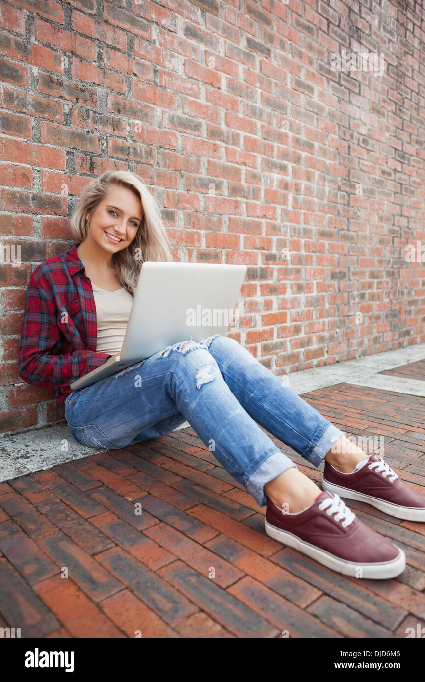 Woman Sitting Against Wall