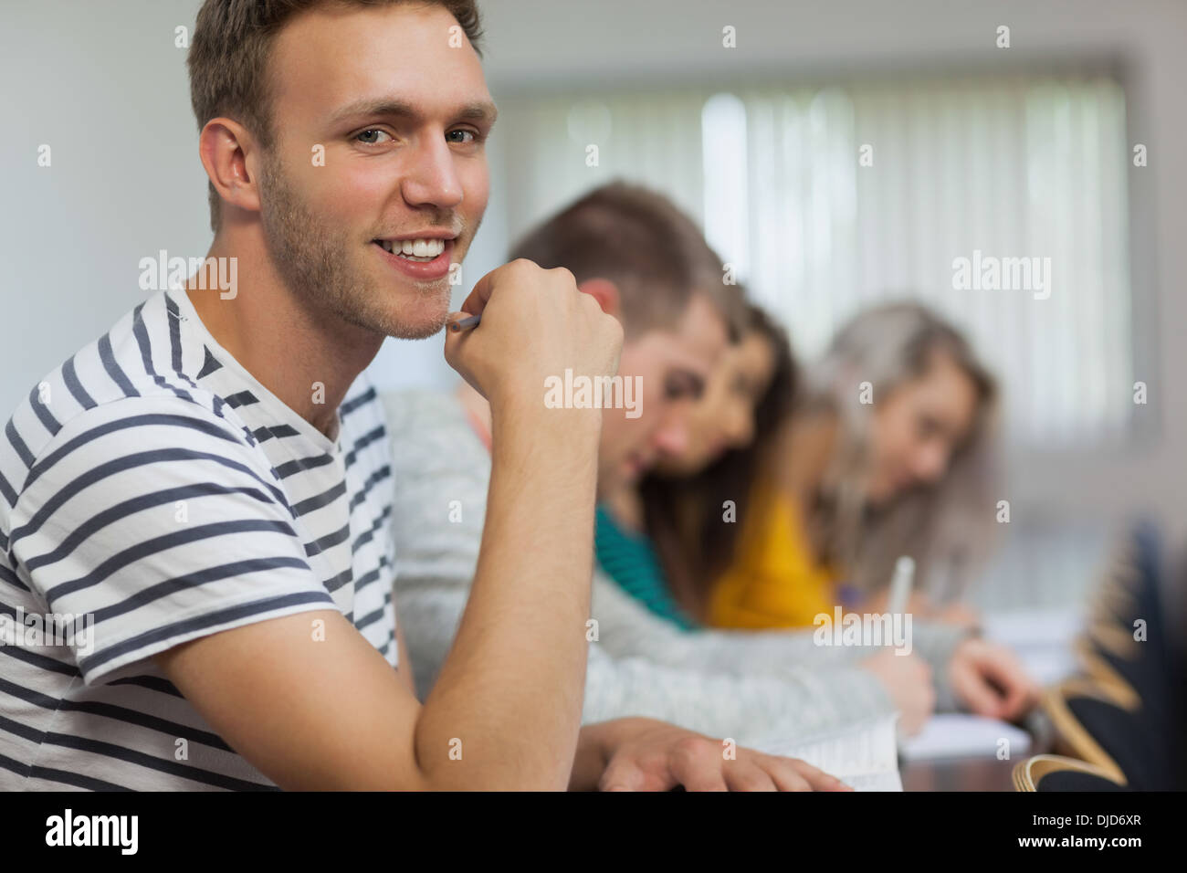 Happy handsome student looking at camera Stock Photo - Alamy