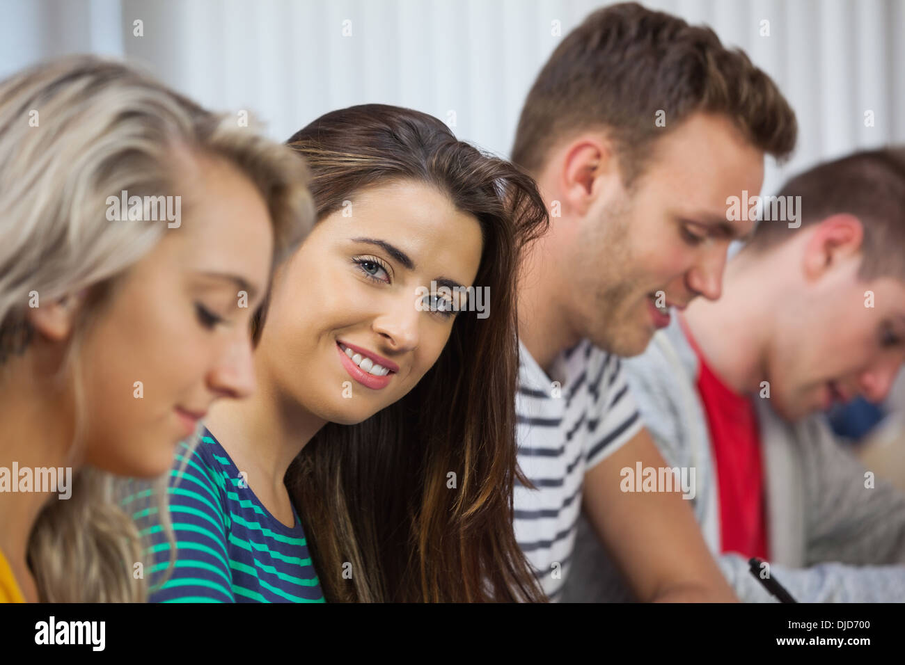 Happy brunette student sitting hi-res stock photography and images - Alamy